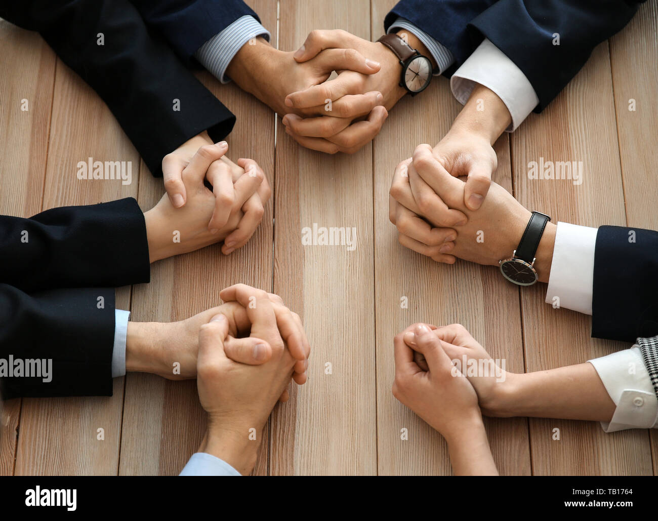 Group of people praying before meeting in office Stock Photo - Alamy