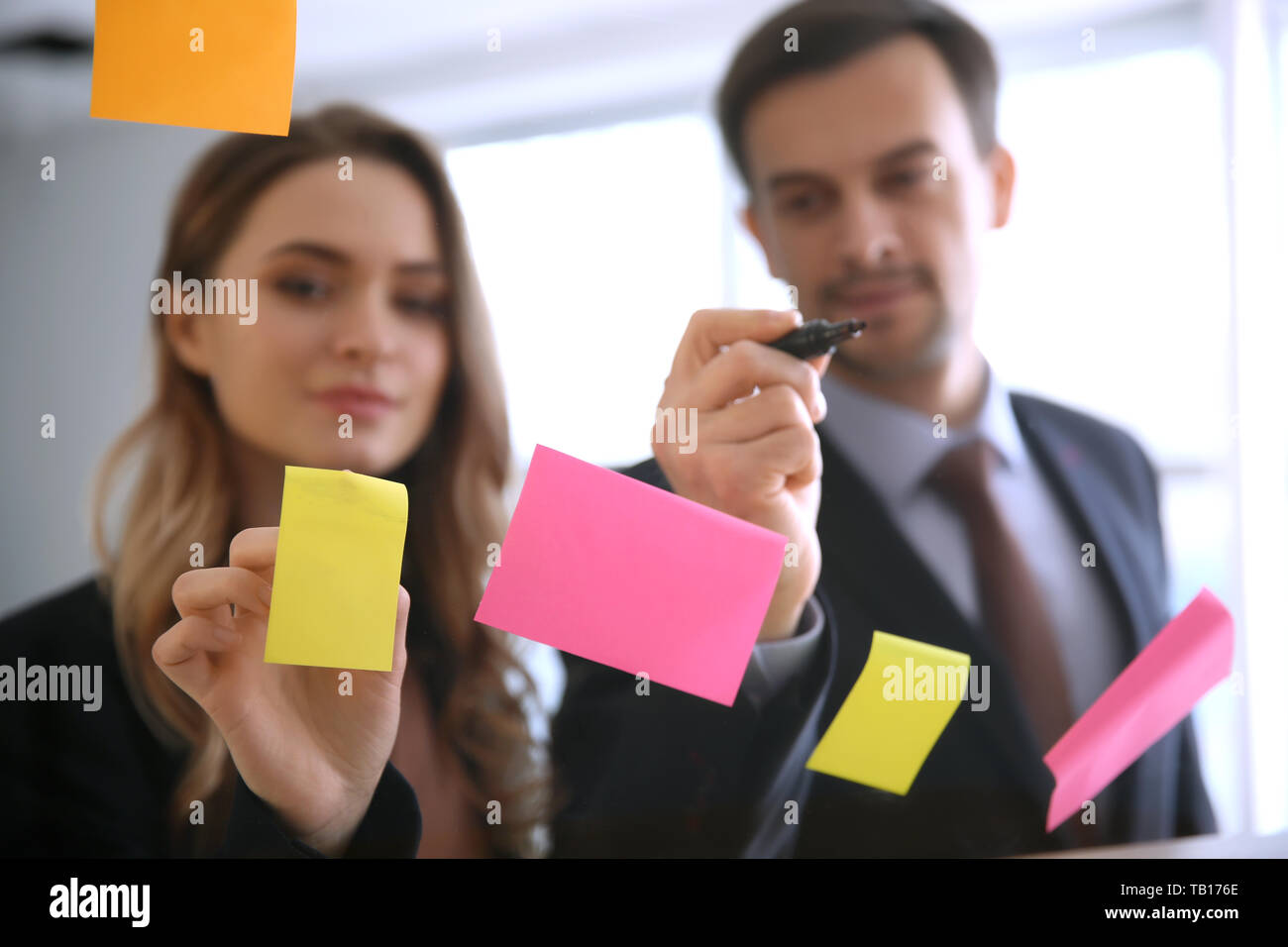 View at business team during meeting in office through transparent ...