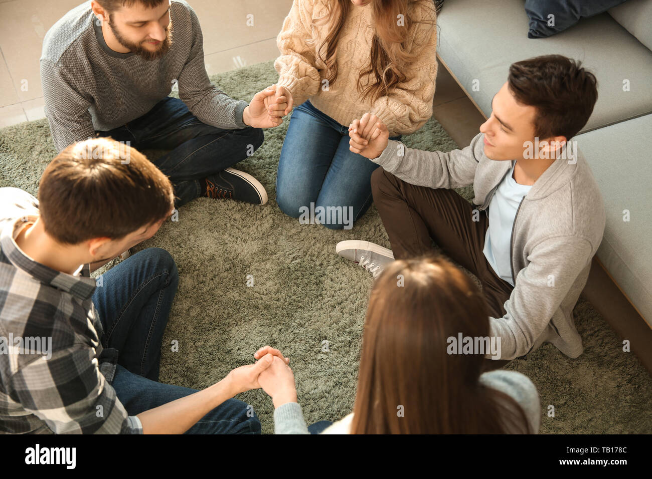 Group of people praying at home Stock Photo - Alamy