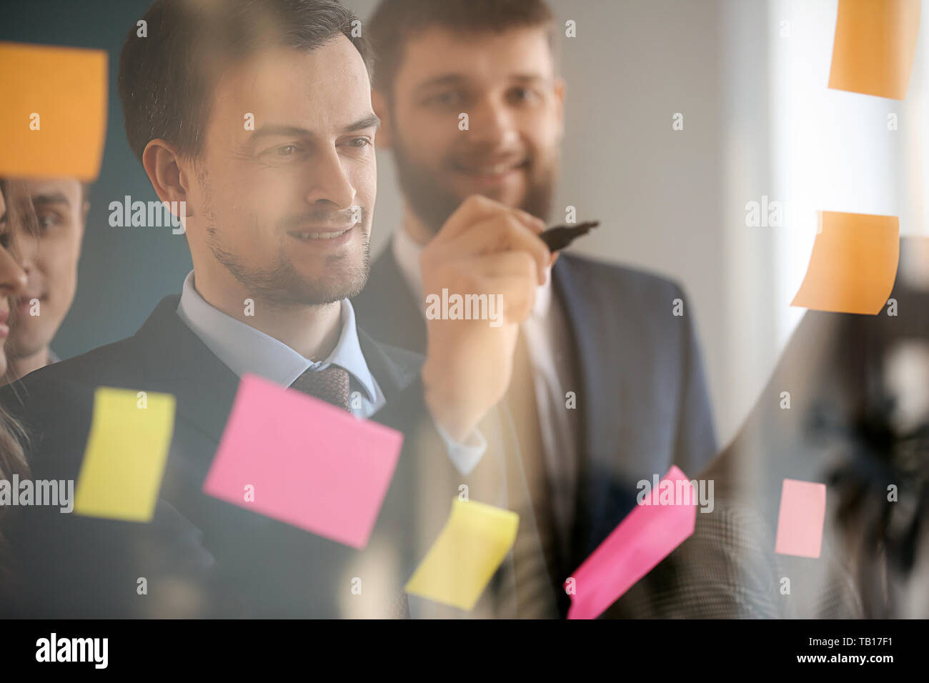 View at business team during meeting in office through transparent ...