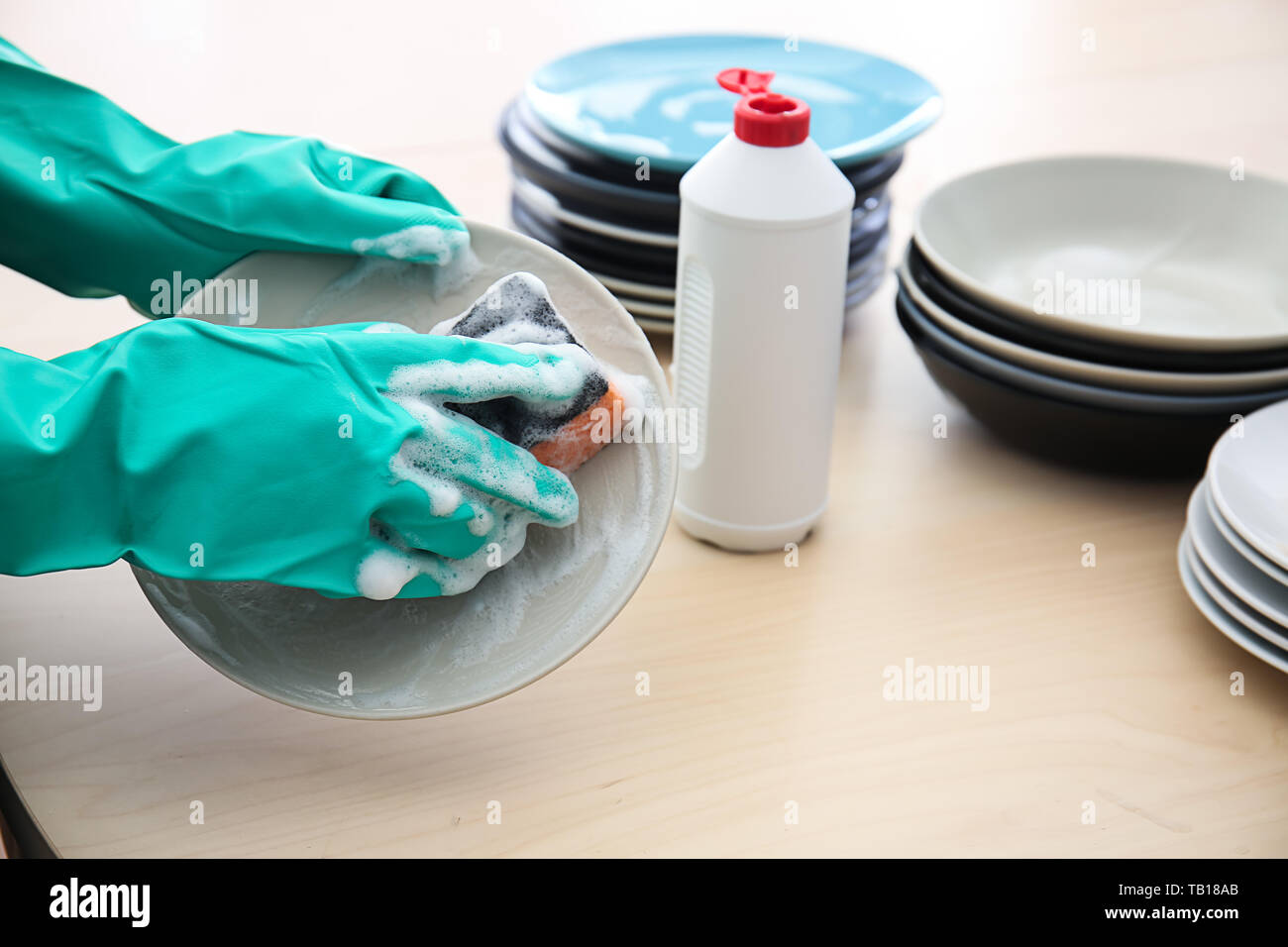 Woman washing dishes in kitchen Stock Photo - Alamy