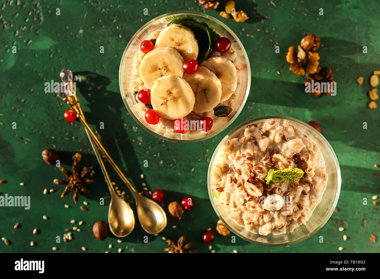 Glasses with tasty oatmeal on color table Stock Photo - Alamy