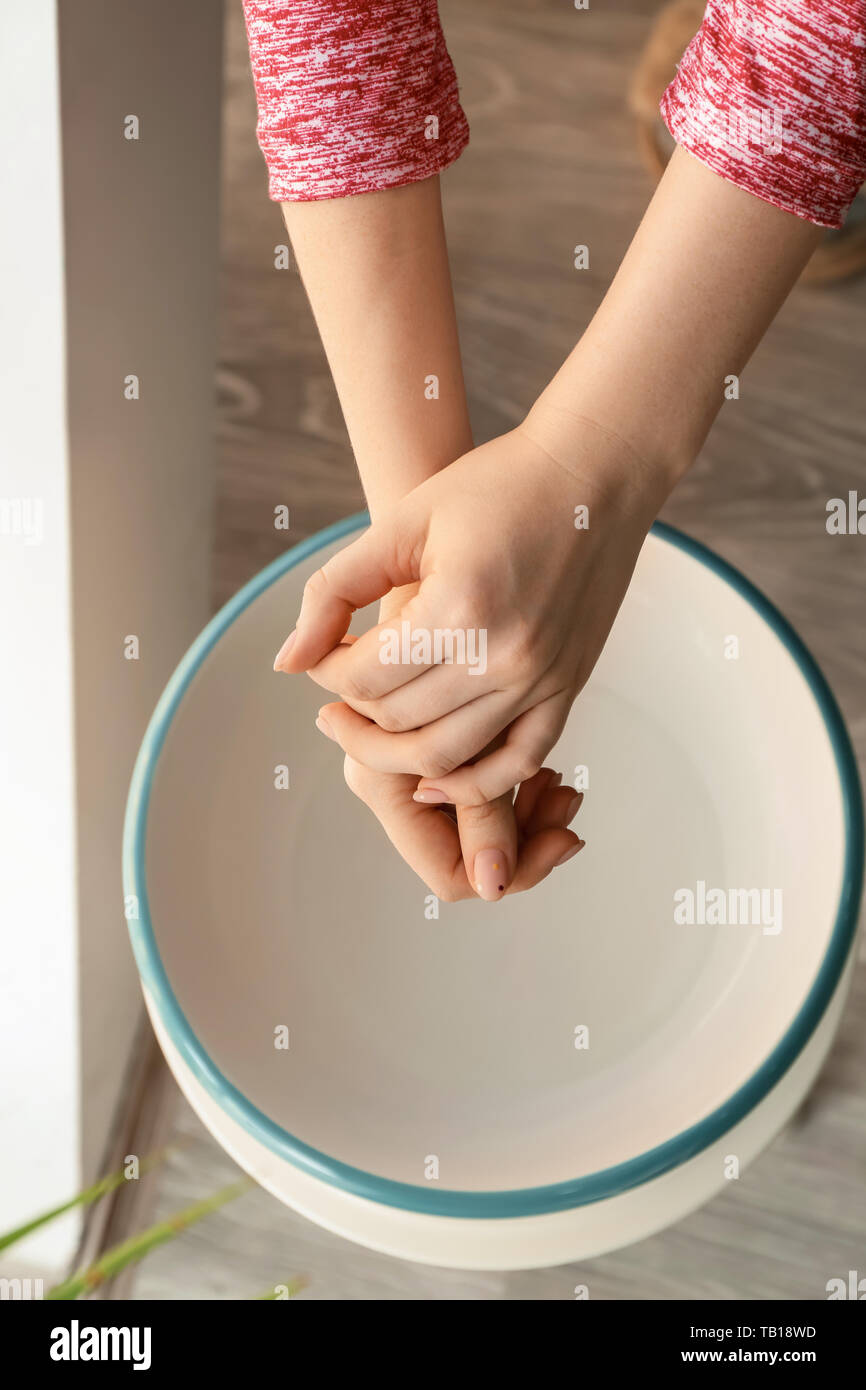 Woman washing hands in bowl Stock Photo - Alamy