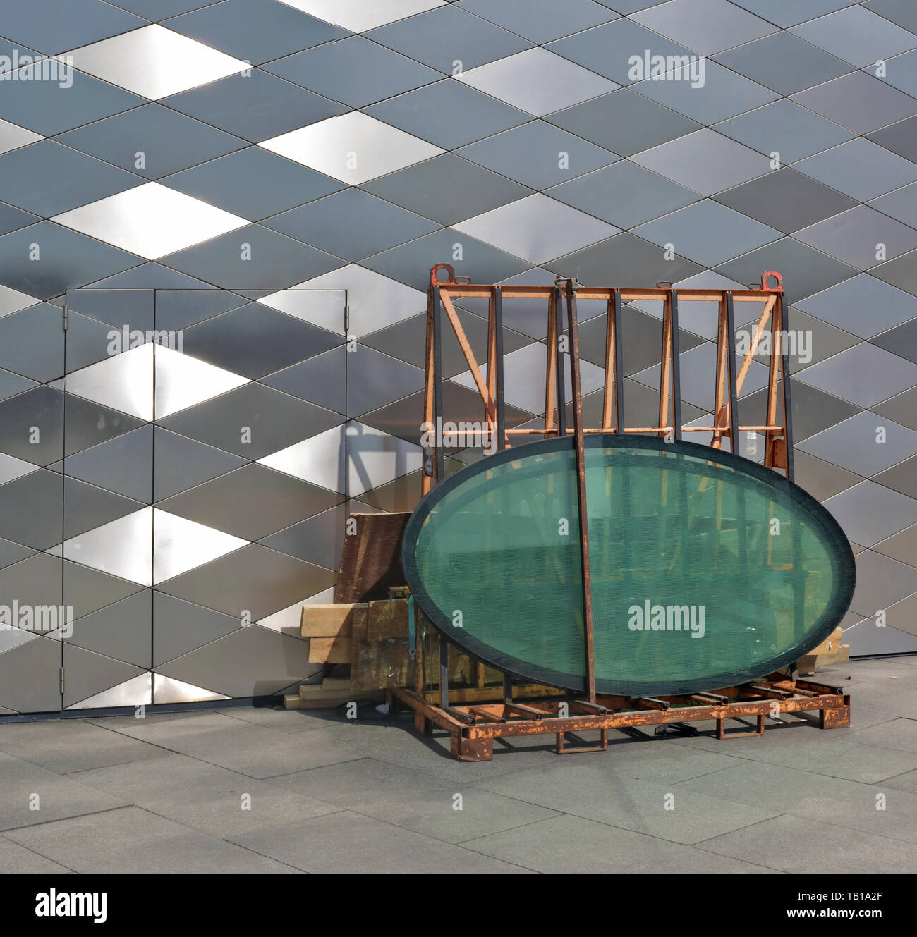 The oval-shaped glass window is ready to be lifted onto a skyscraper ...