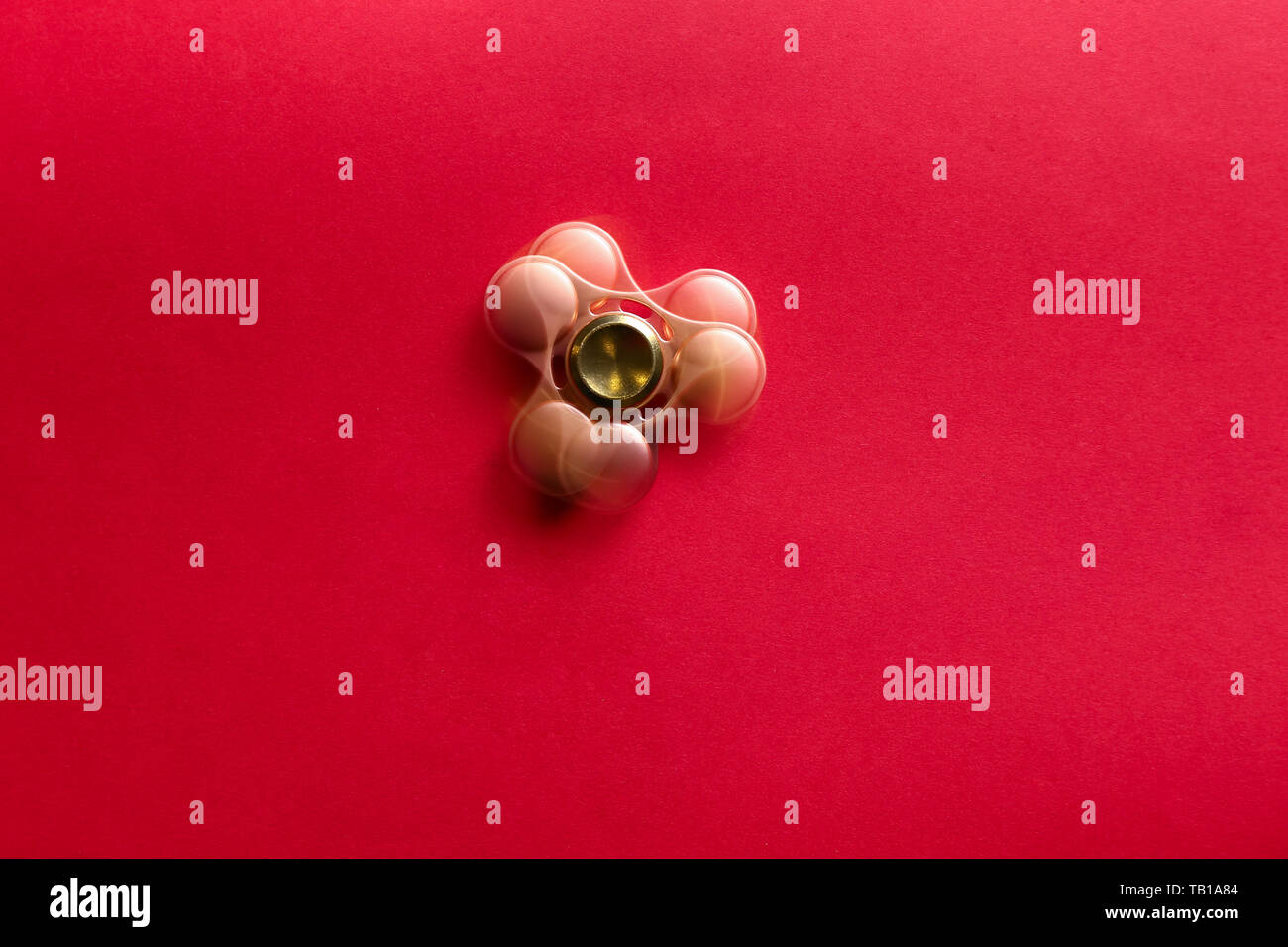 Stroboscopic photo of moving spinner on color background Stock Photo ...