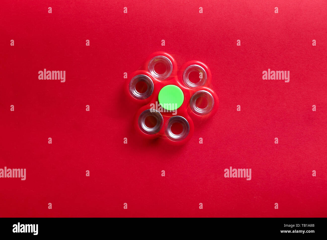 Stroboscopic photo of moving spinner on color background Stock Photo ...