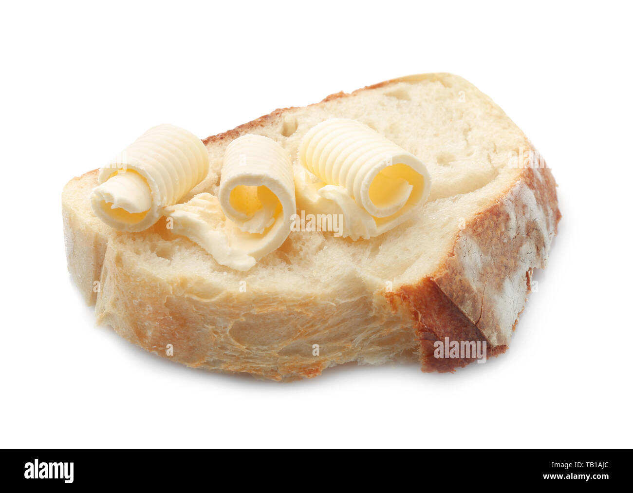 Slice of bread with butter curls on white background Stock Photo - Alamy