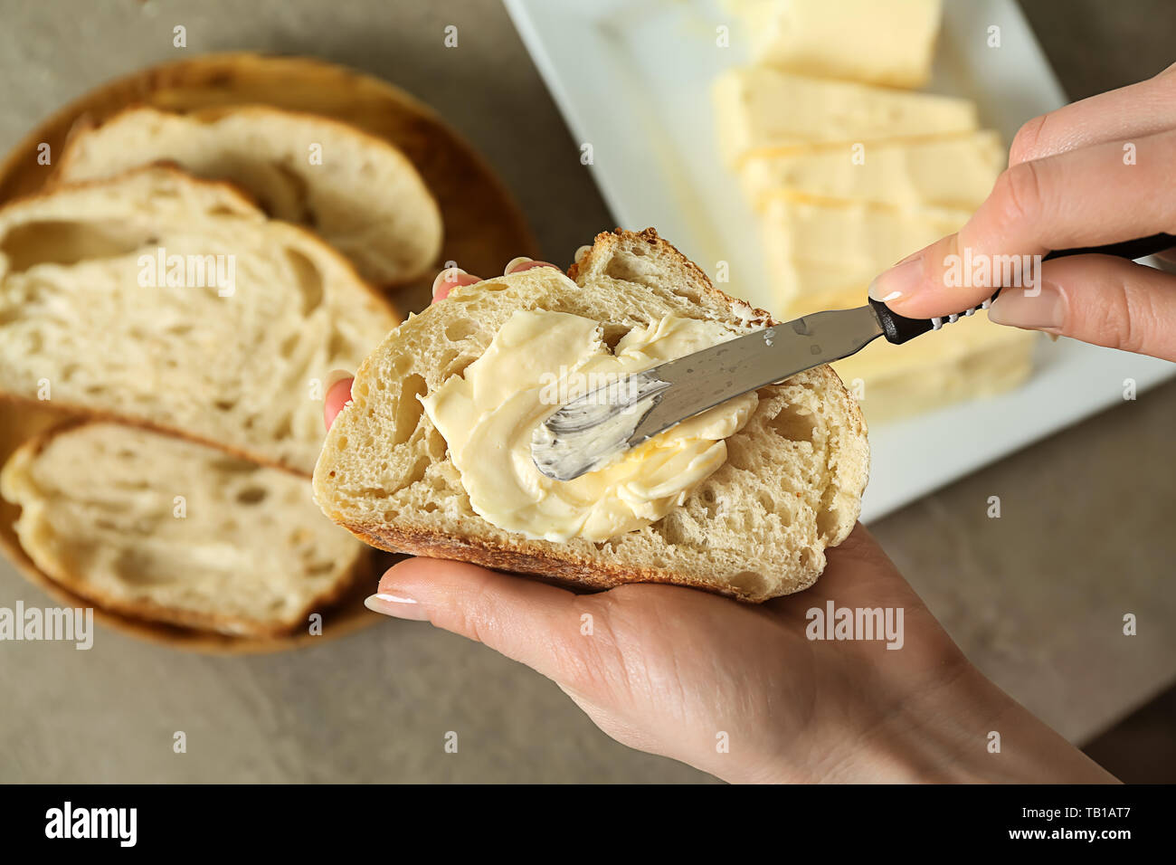 Young woman spreading butter hi-res stock photography and images - Alamy