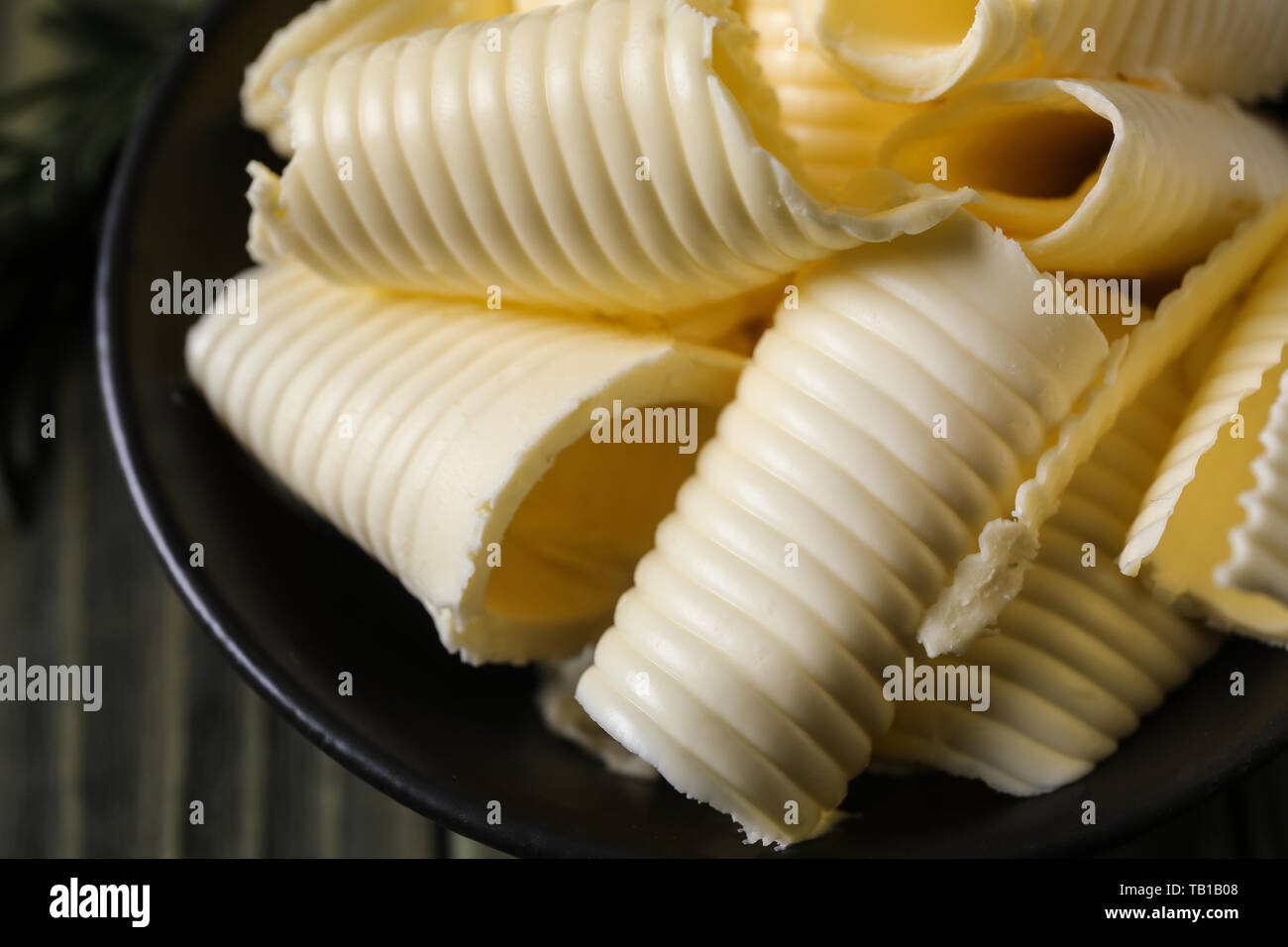 Tasty butter curls in bowl, closeup Stock Photo - Alamy