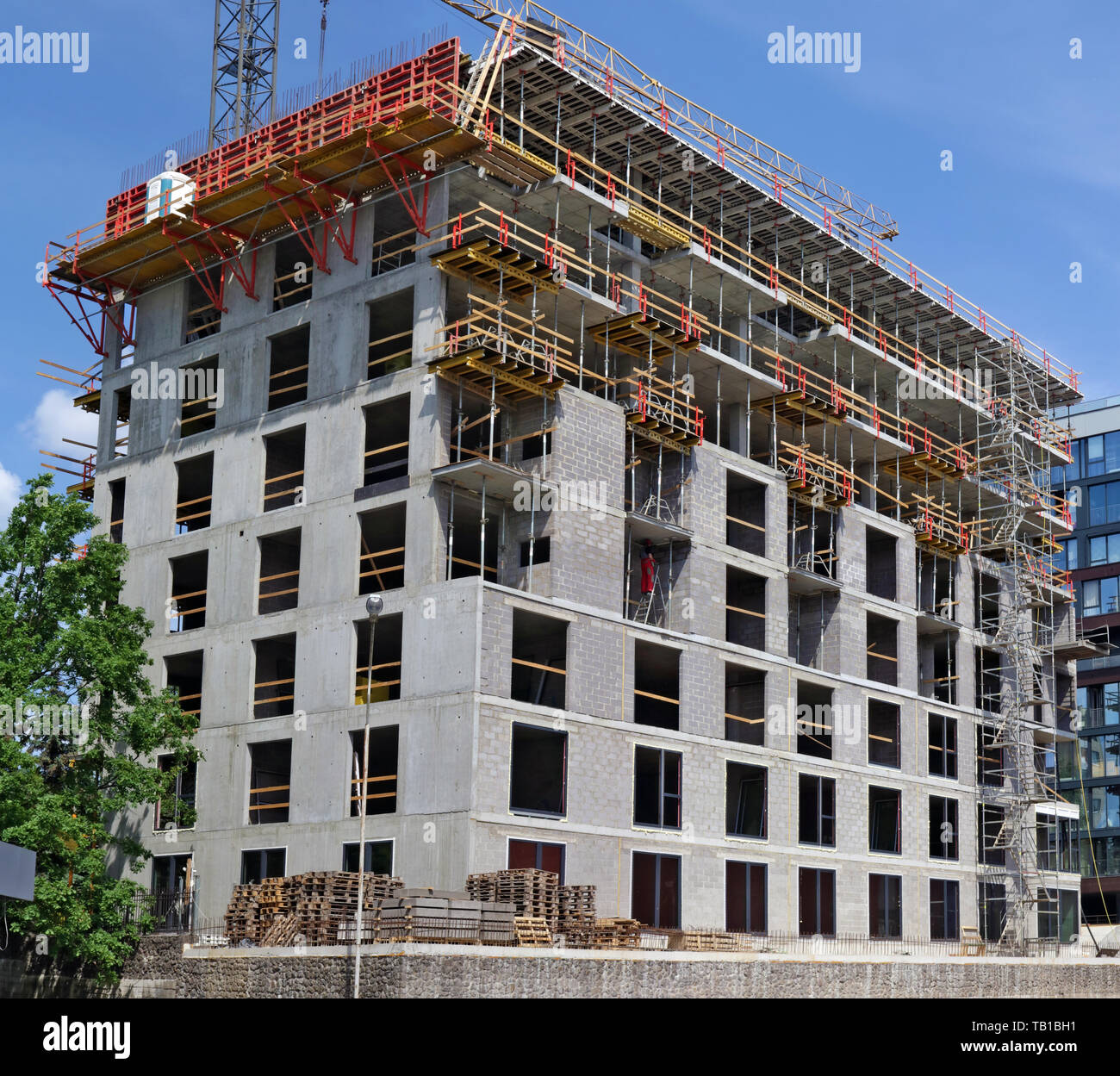 Modern construction metal scaffolding on the wall of a new house. Sunny ...