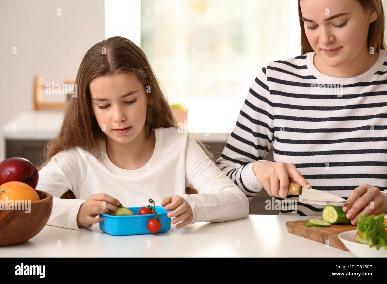 Mother preparing school lunch for her daughter at home Stock Photo - Alamy