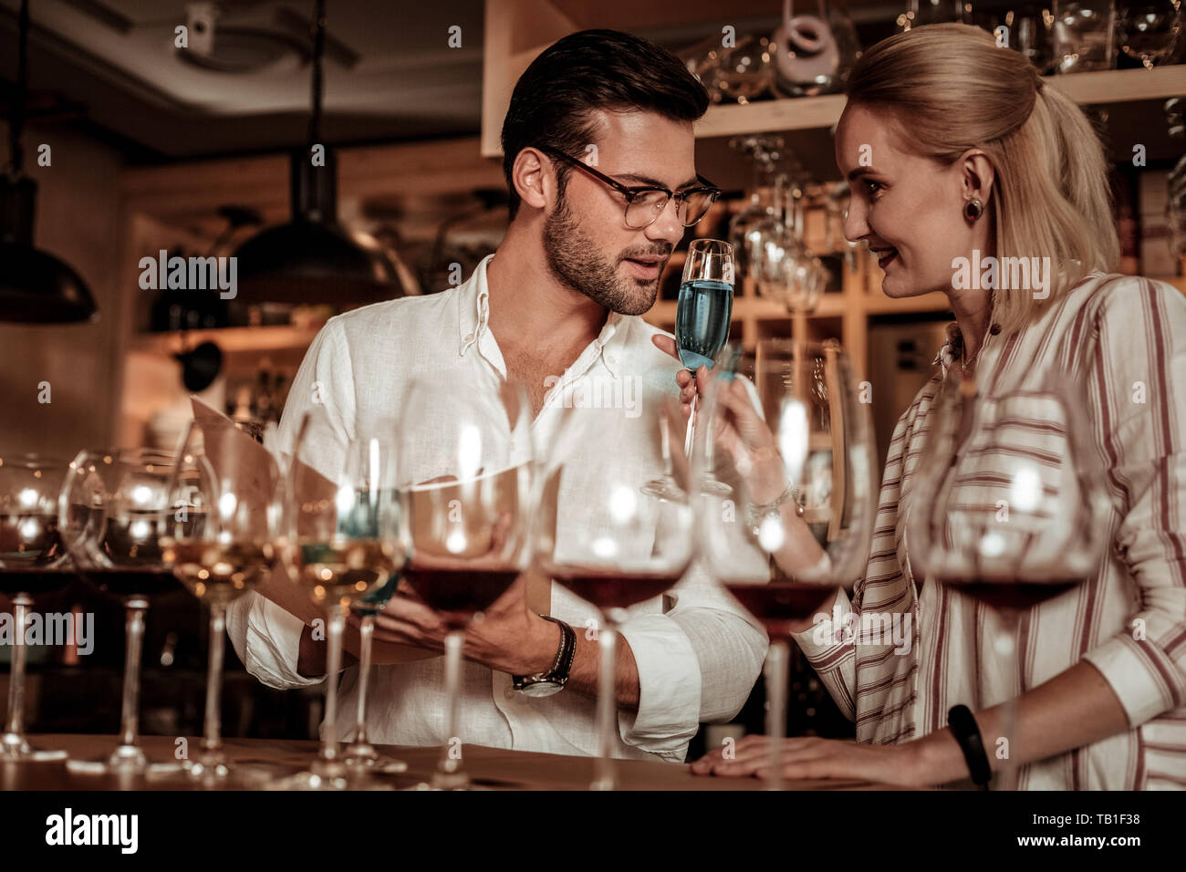 Positive delighted young people tasting alcohol drinks Stock Photo - Alamy