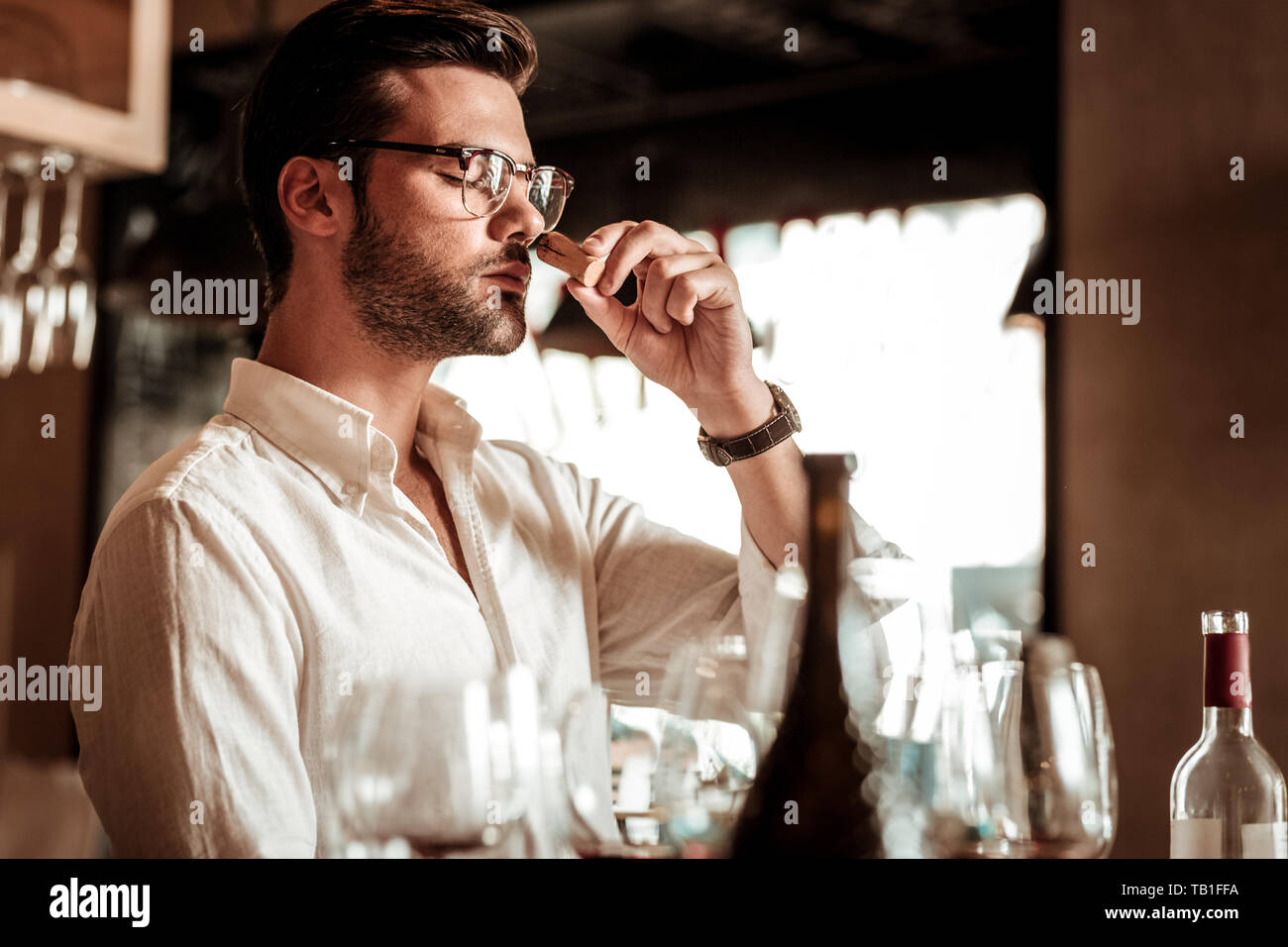 Pleased young man standing in semi position Stock Photo - Alamy