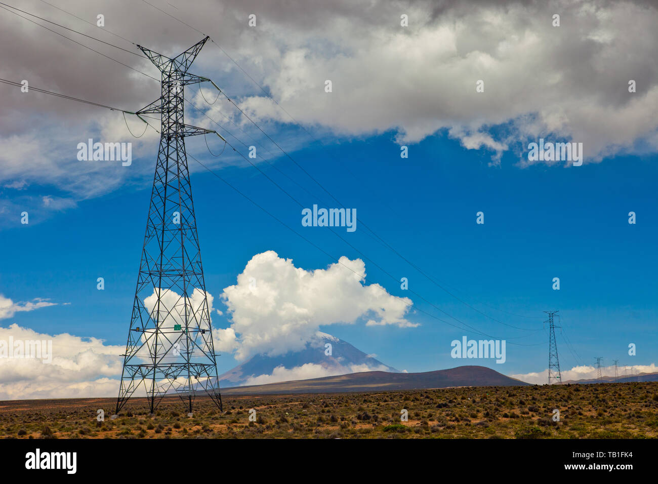 Power lines at Andes in Peru in front of an active volcano Stock Photo ...