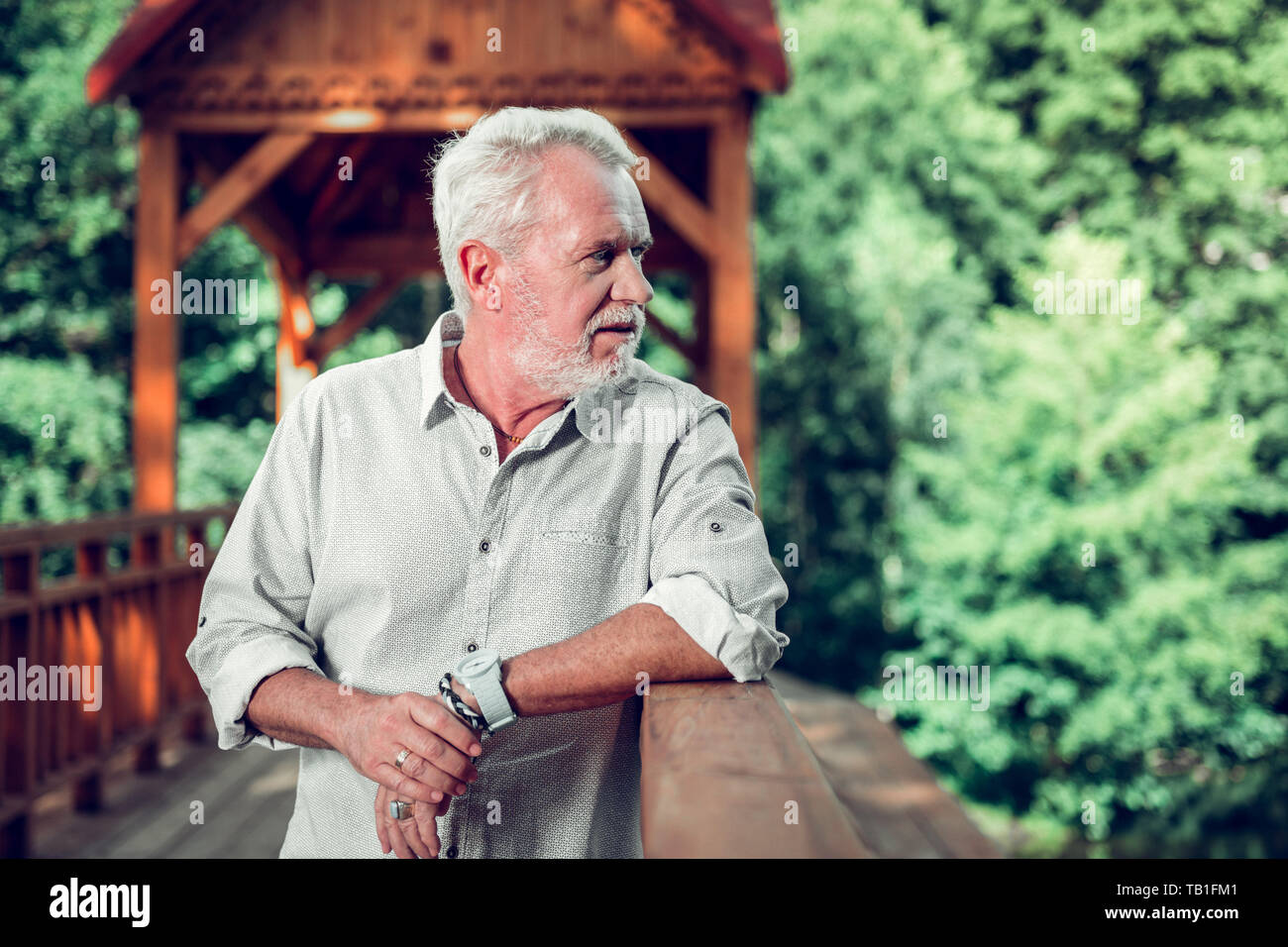 Face portrait of man leaning on the wooden bridge Stock Photo - Alamy