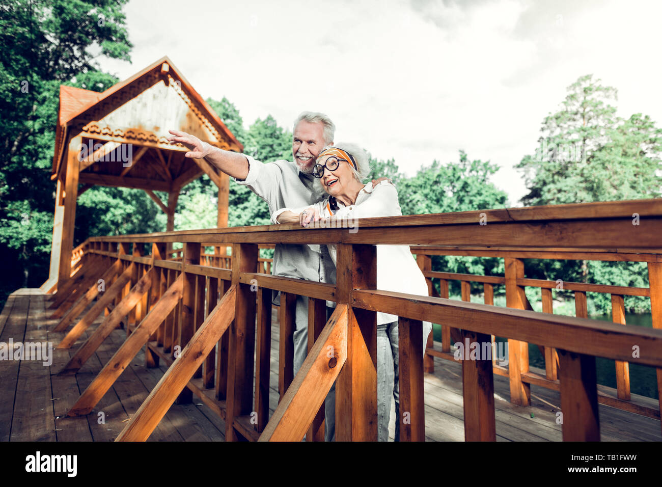 Happy couple standing on bridge and enjoying the nature scenery Stock ...