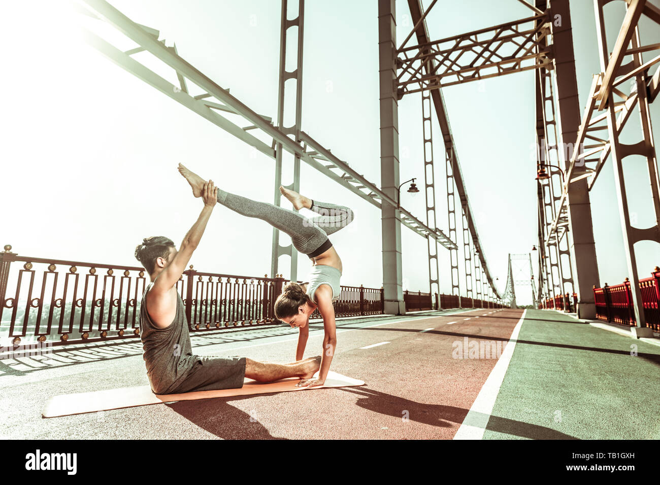 Dark-haired female yogi standing in a handstand pose Stock Photo - Alamy