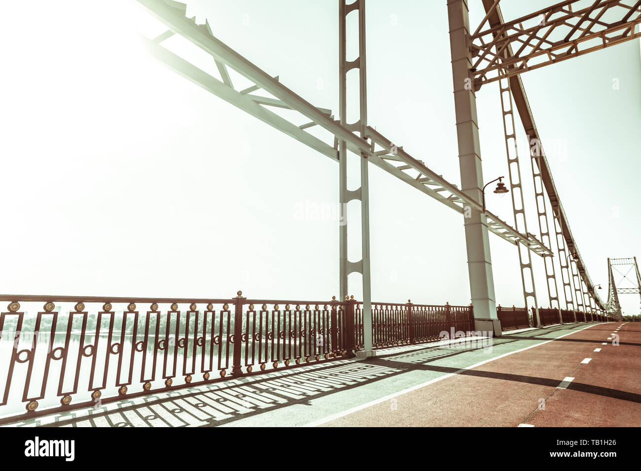 Pedestrian bridge over the river in the city Stock Photo - Alamy