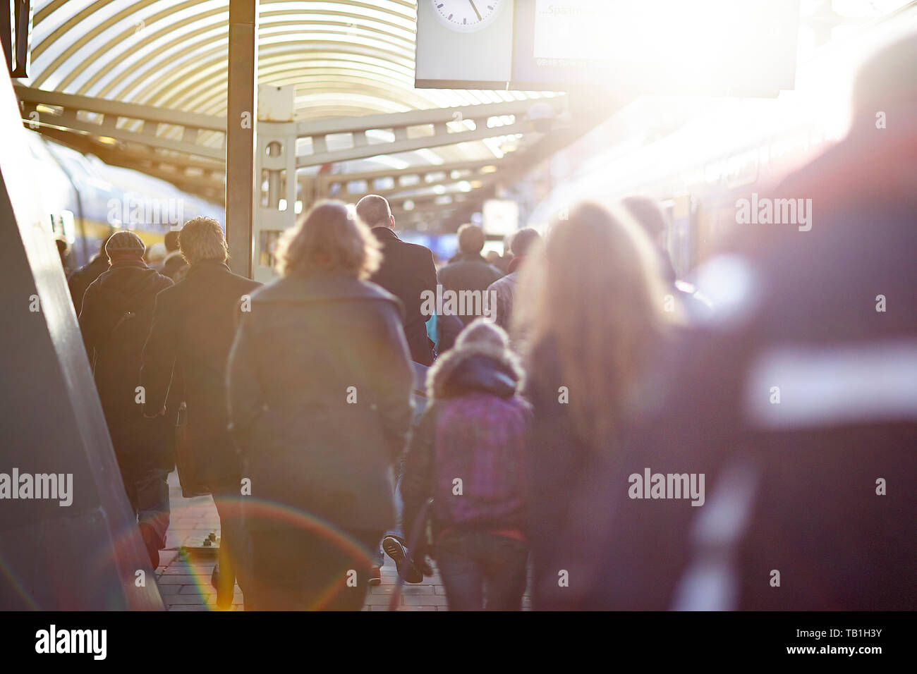 Commuters walking on a busy platform arriving in the city centre in the ...