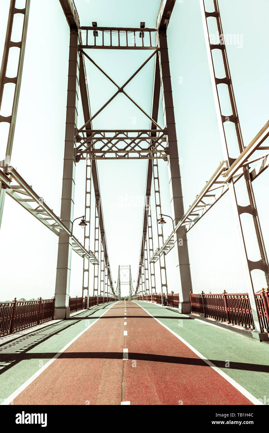 Green and red footpath on the modern bridge Stock Photo - Alamy