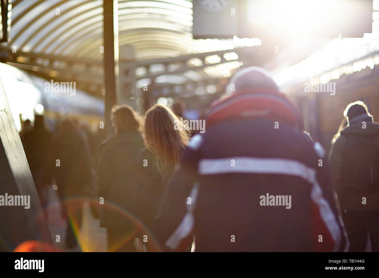 Commuters walking on a busy platform arriving in the city centre in the ...