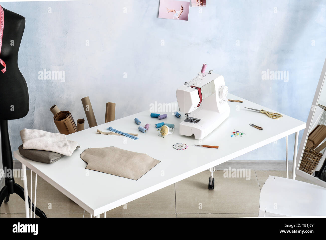 Stylish workplace of tailor with sewing machine in workshop Stock Photo ...