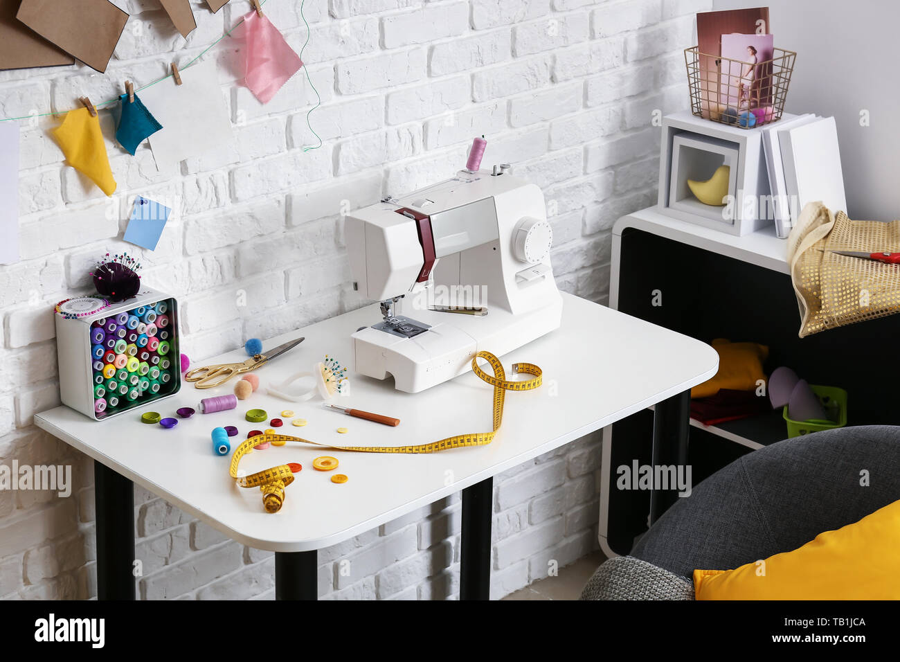 Stylish workplace of tailor with sewing machine in workshop Stock Photo ...