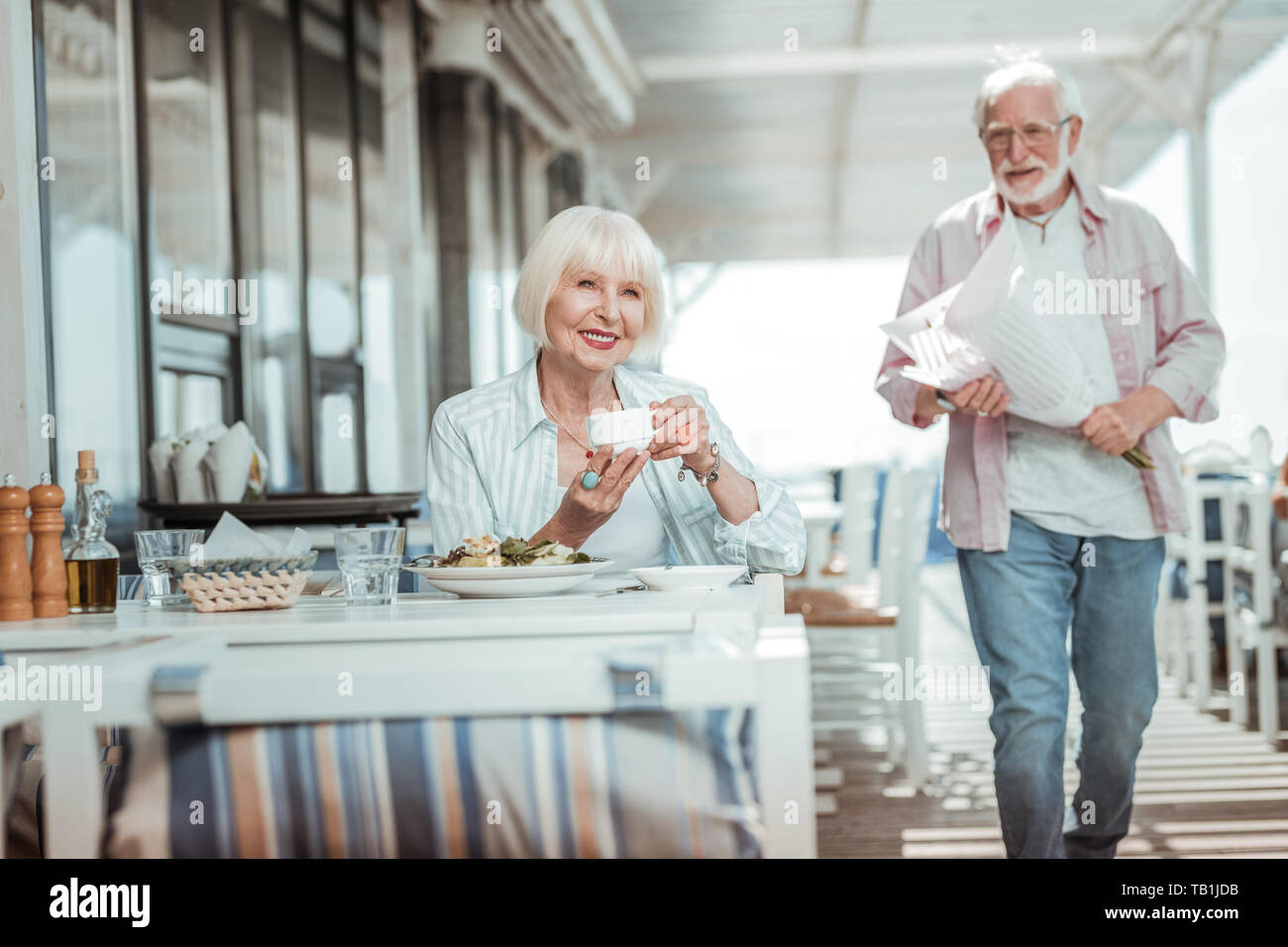 Pleased mature woman waiting for her husband Stock Photo - Alamy