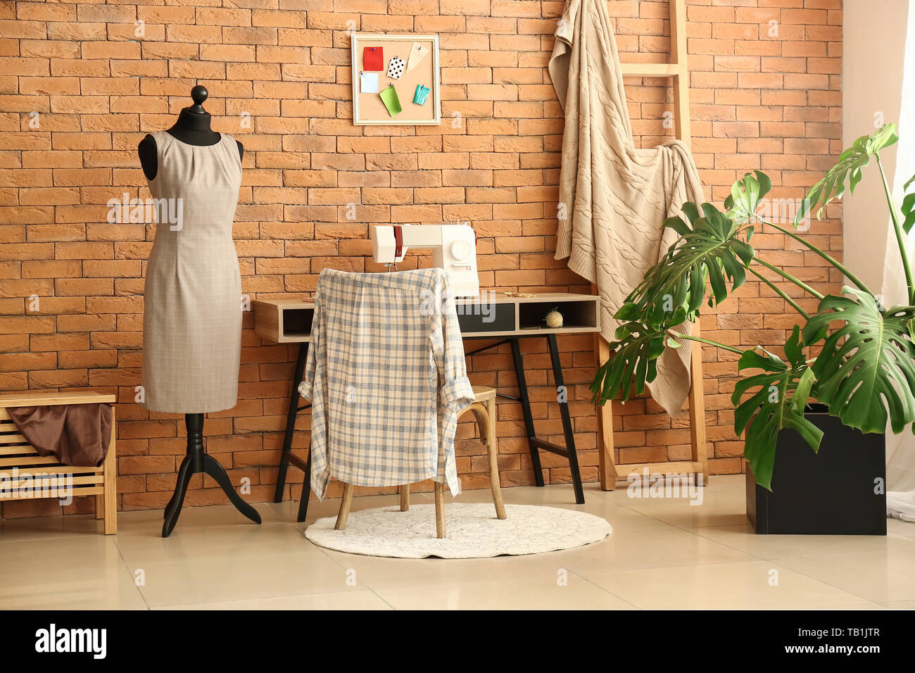 Stylish tailor's workplace in interior of workshop Stock Photo - Alamy