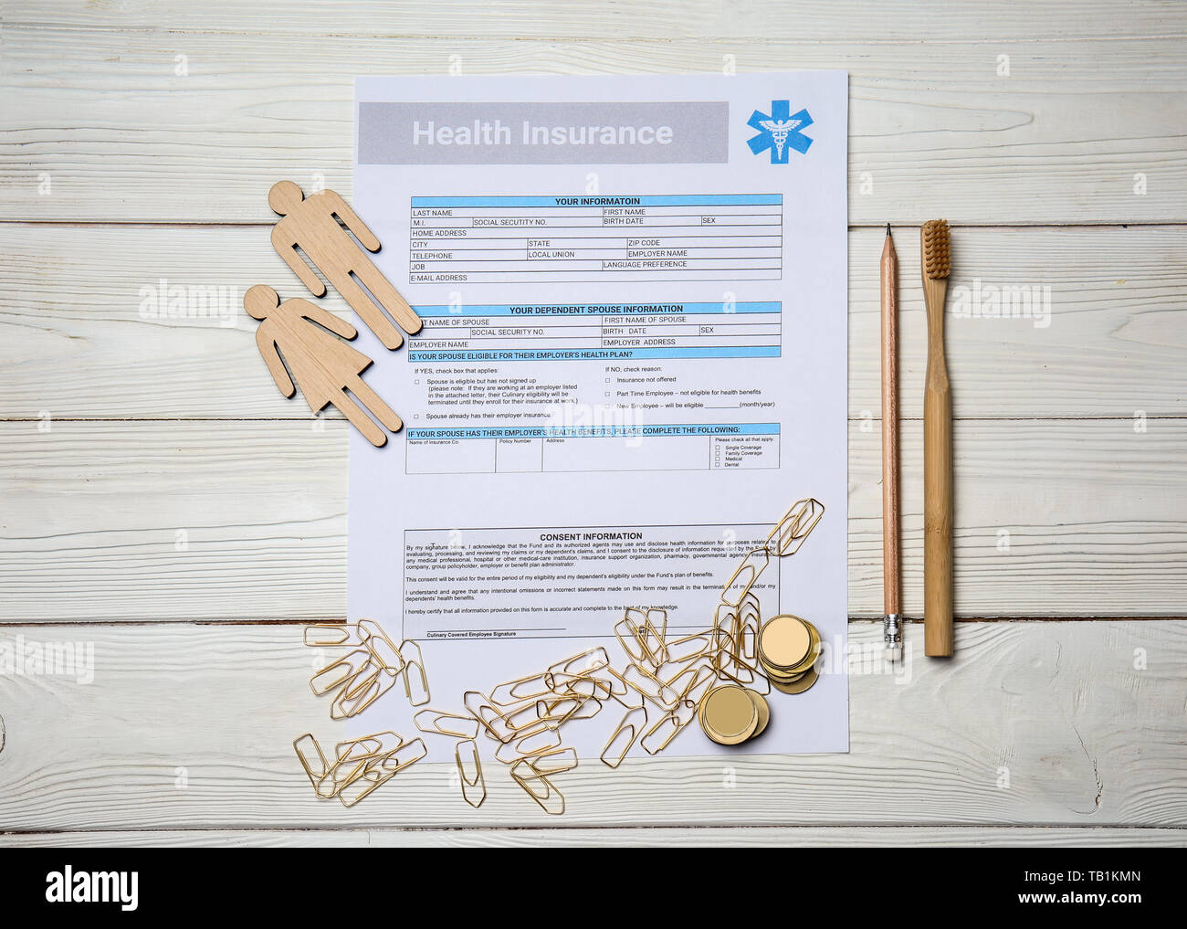 Health insurance form with human figures on white table Stock Photo - Alamy