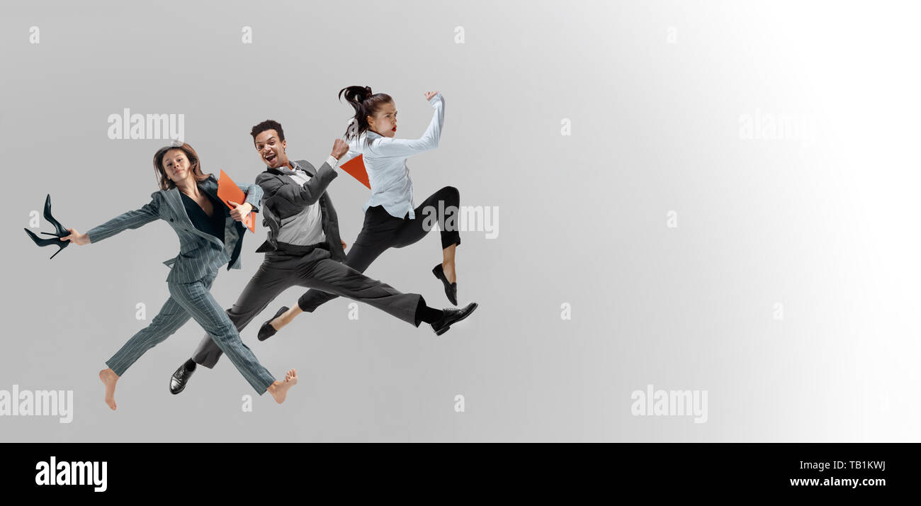 Happy office workers jumping and dancing in casual clothes or suit with ...