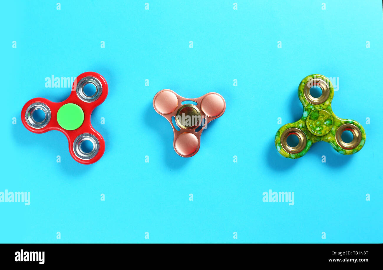 Different spinners on color background Stock Photo - Alamy