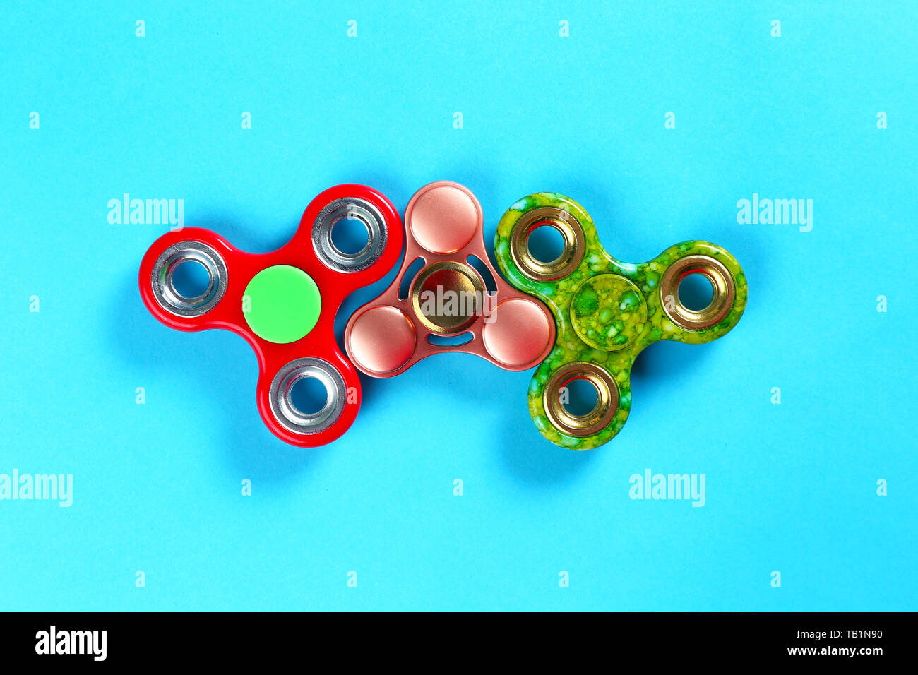 Different spinners on color background Stock Photo - Alamy