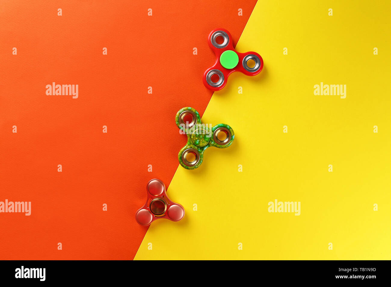 Different spinners on color background Stock Photo - Alamy