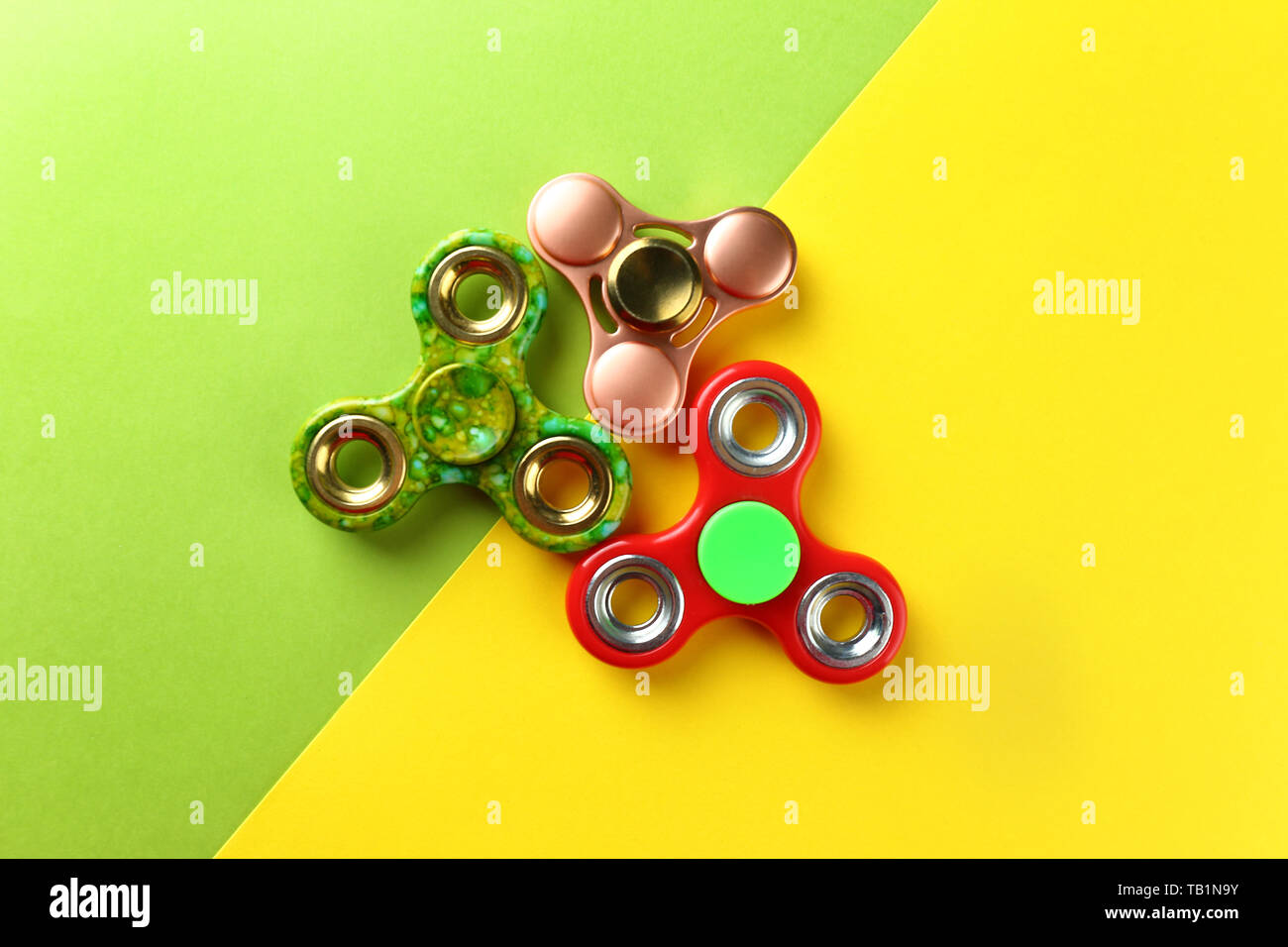 Different spinners on color background Stock Photo - Alamy