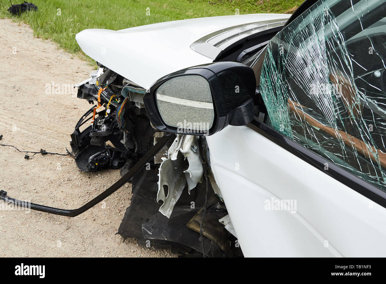 reflection of road in a mirror of car after frontal collision with ...