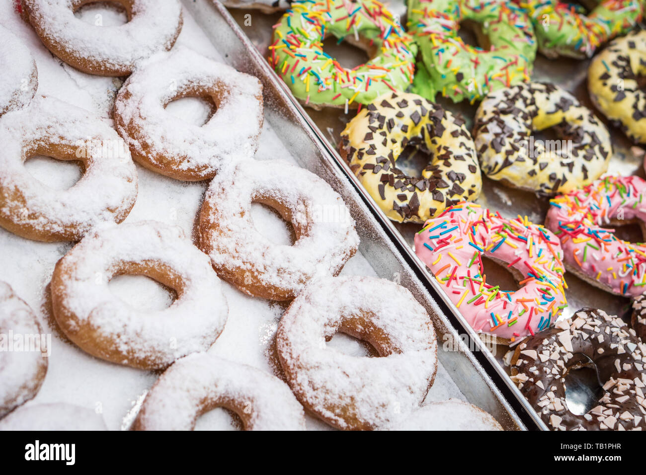 Set of different colorful glazed donuts. Unhealthy junk food concept ...