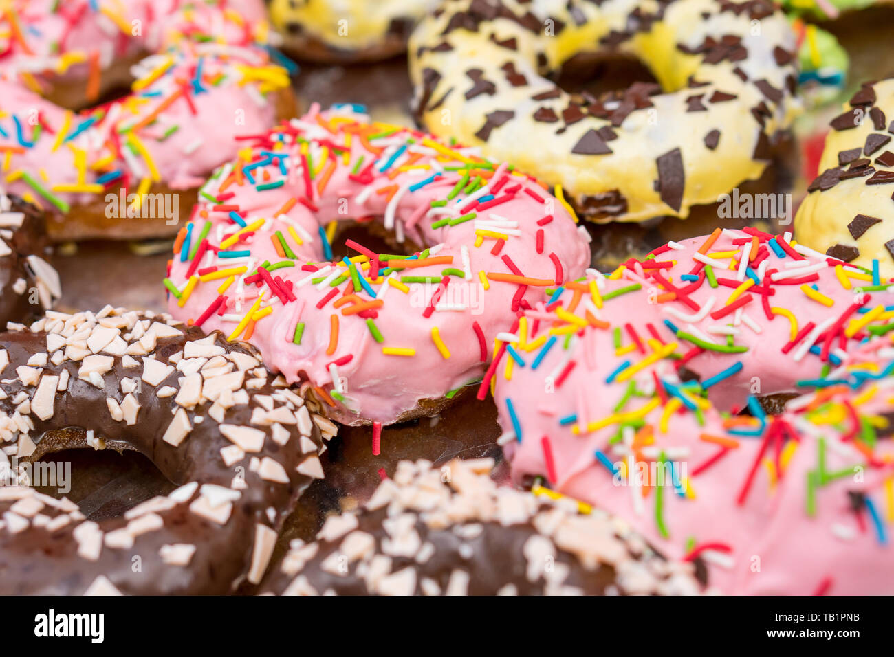 Set of different colorful glazed donuts. Unhealthy junk food concept ...
