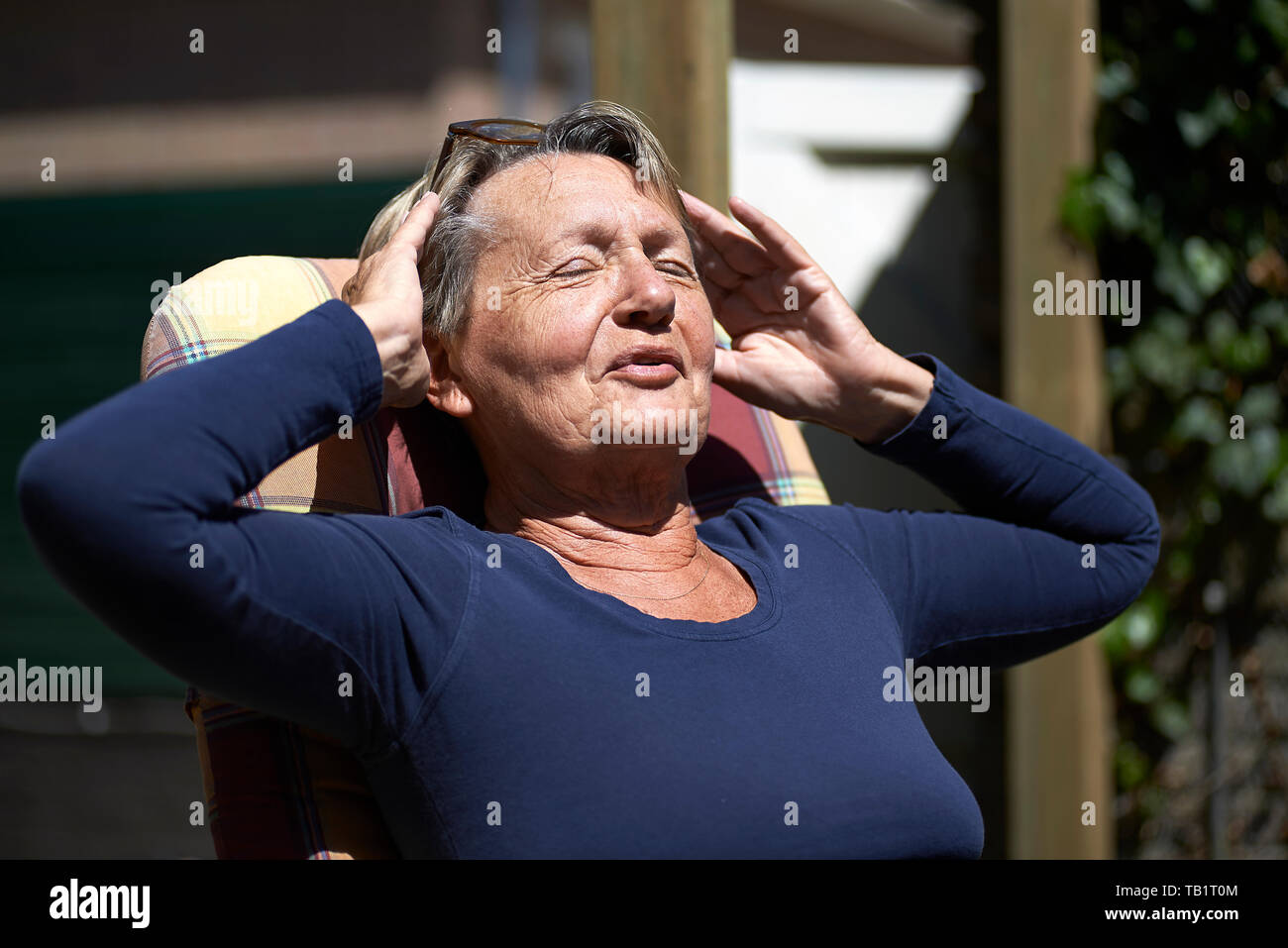 Elderly sunbathing in garden hi-res stock photography and images - Alamy