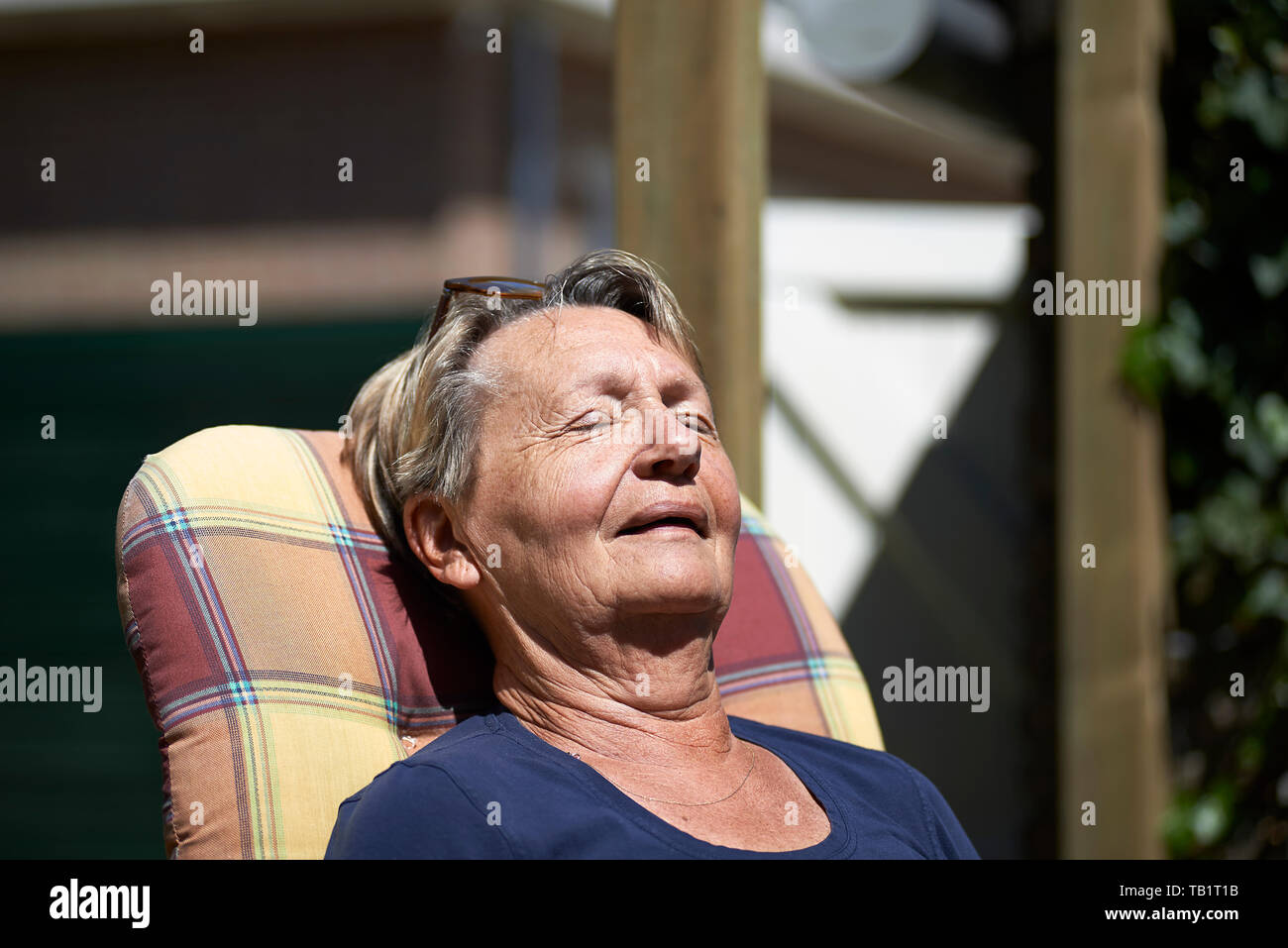 Affluent elderly caucasian woman enjoying herself sitting outside in ...