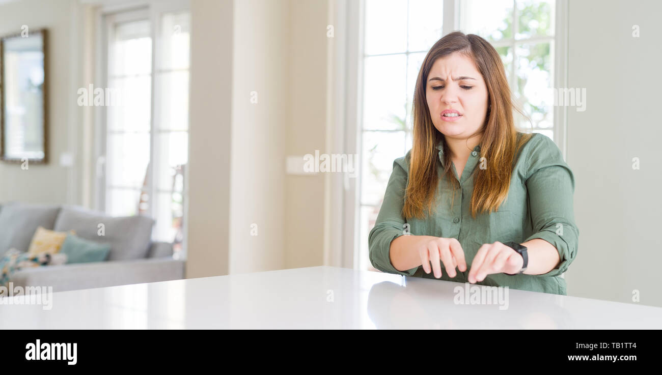 Beautiful young woman at home disgusted expression, displeased and ...