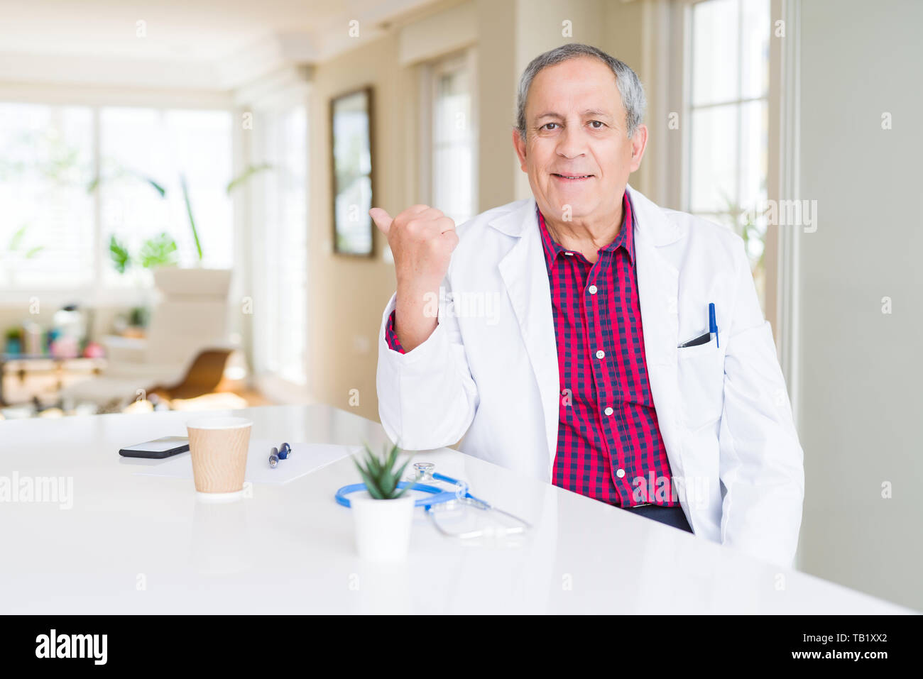 Handsome senior doctor man wearing medical coat at the clinic smiling ...