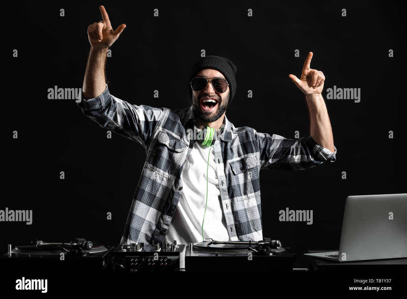 Male DJ playing music on dark background Stock Photo - Alamy