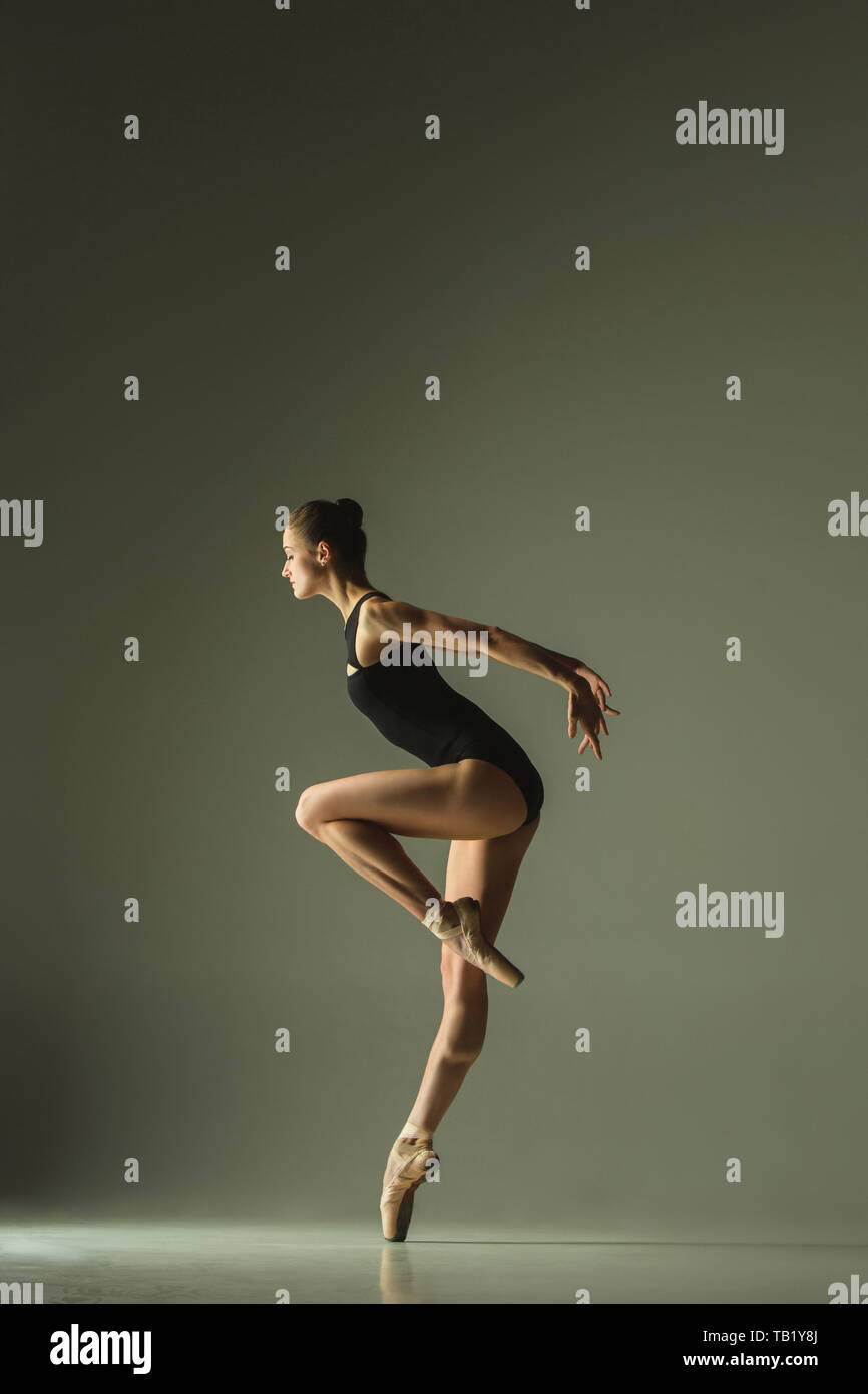 Graceful ballet dancer or classic ballerina dancing isolated on grey ...
