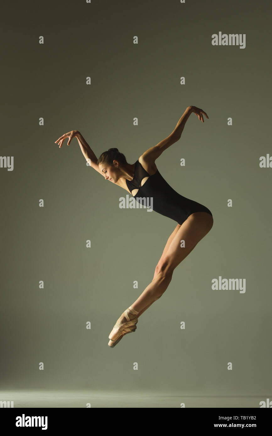 Graceful ballet dancer or classic ballerina dancing isolated on grey ...