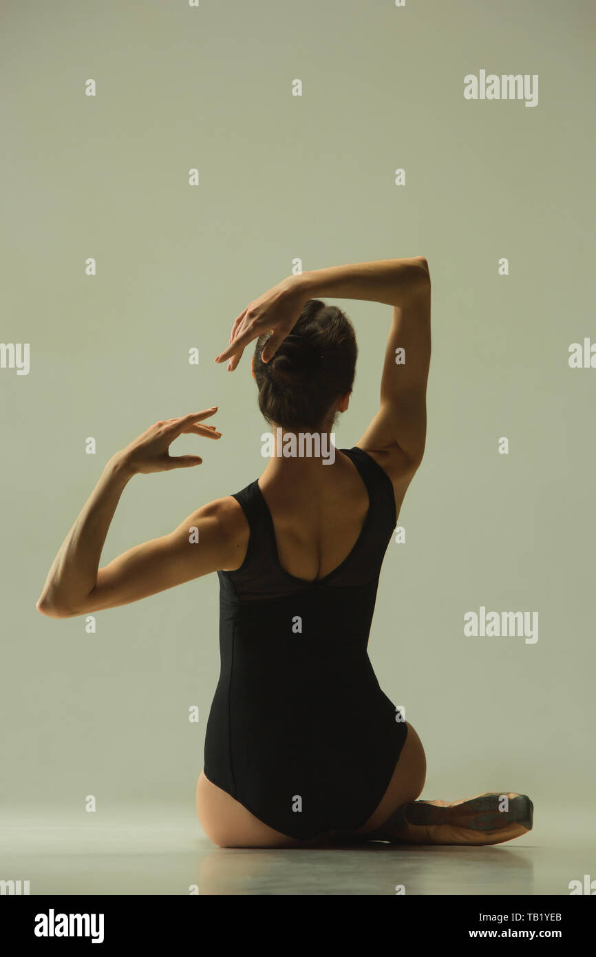 Graceful ballet dancer or classic ballerina dancing isolated on grey ...