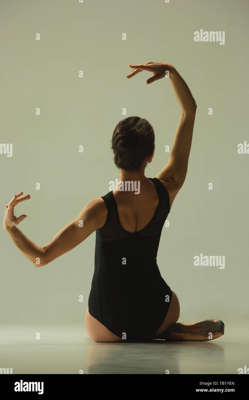 Graceful ballet dancer or classic ballerina dancing isolated on grey ...