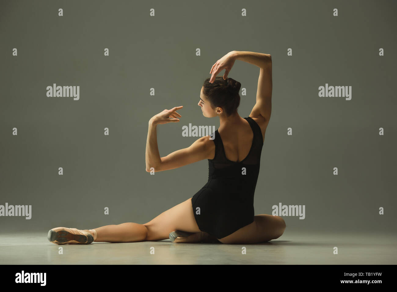 Graceful ballet dancer or classic ballerina dancing isolated on grey ...
