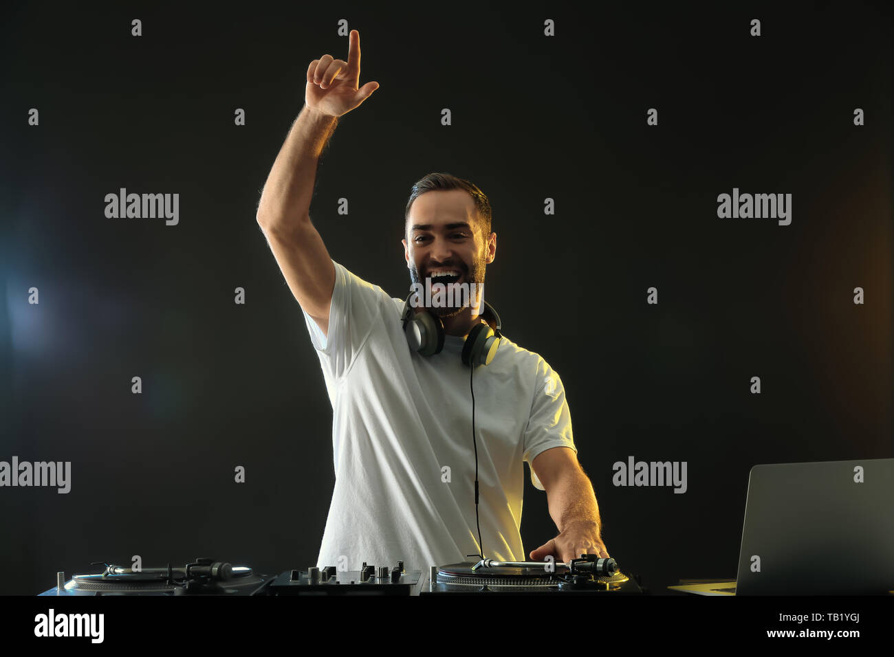 Male DJ playing music in club Stock Photo - Alamy