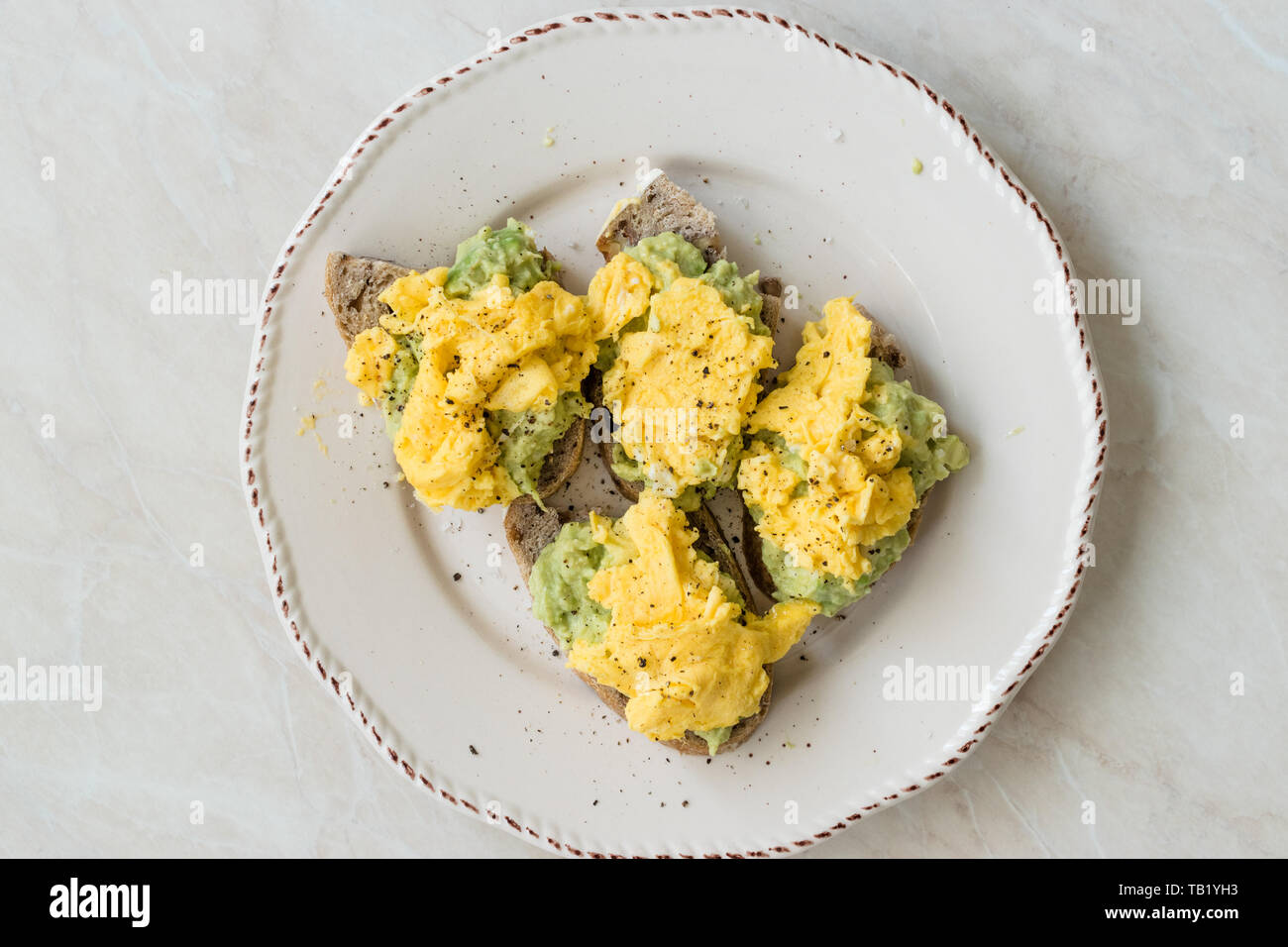 Scrambled Eggs with Avocado on Toast Bread for Breakfast. Organic Food ...